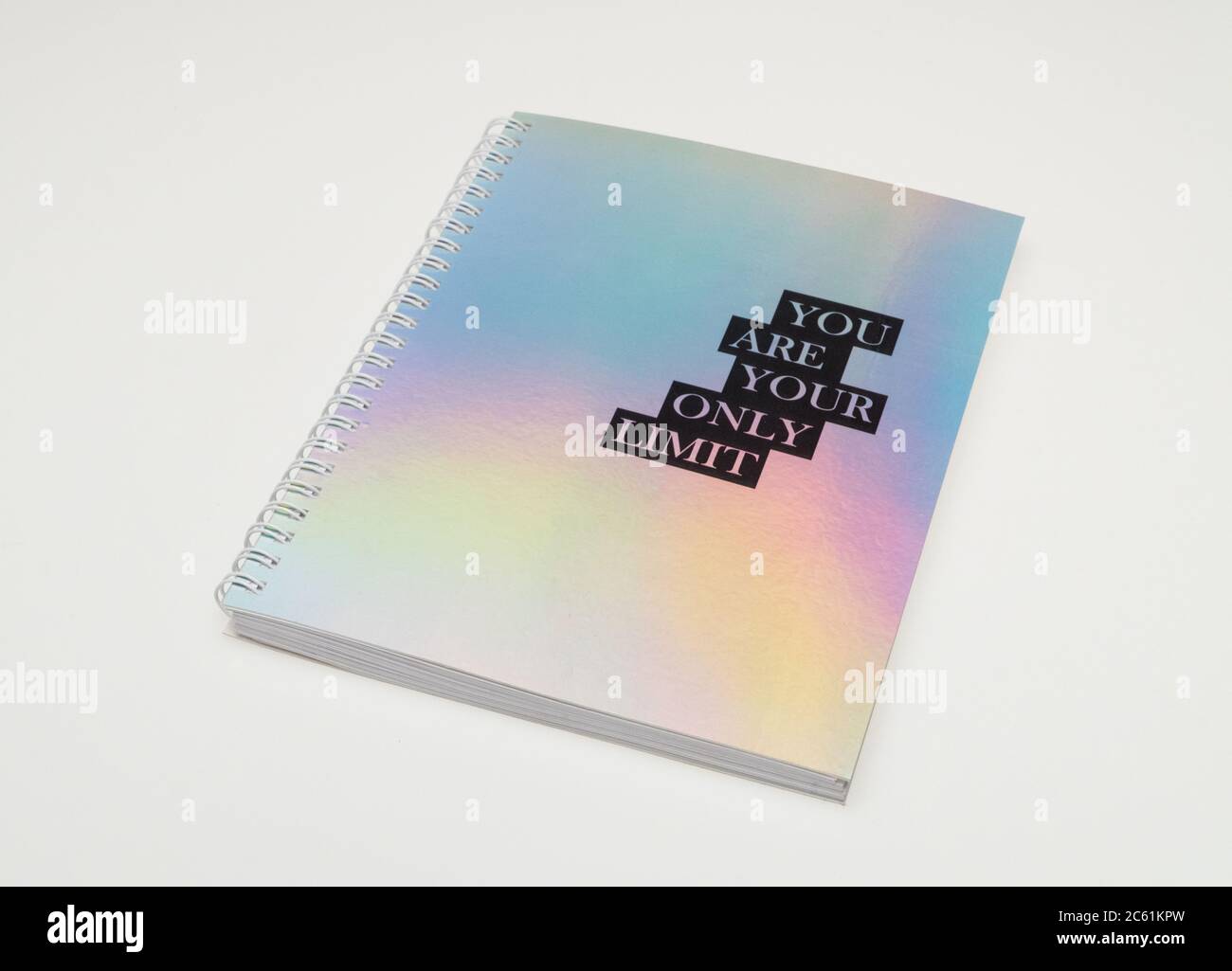 a notebook with iridiscent cover and motivational text, white ...