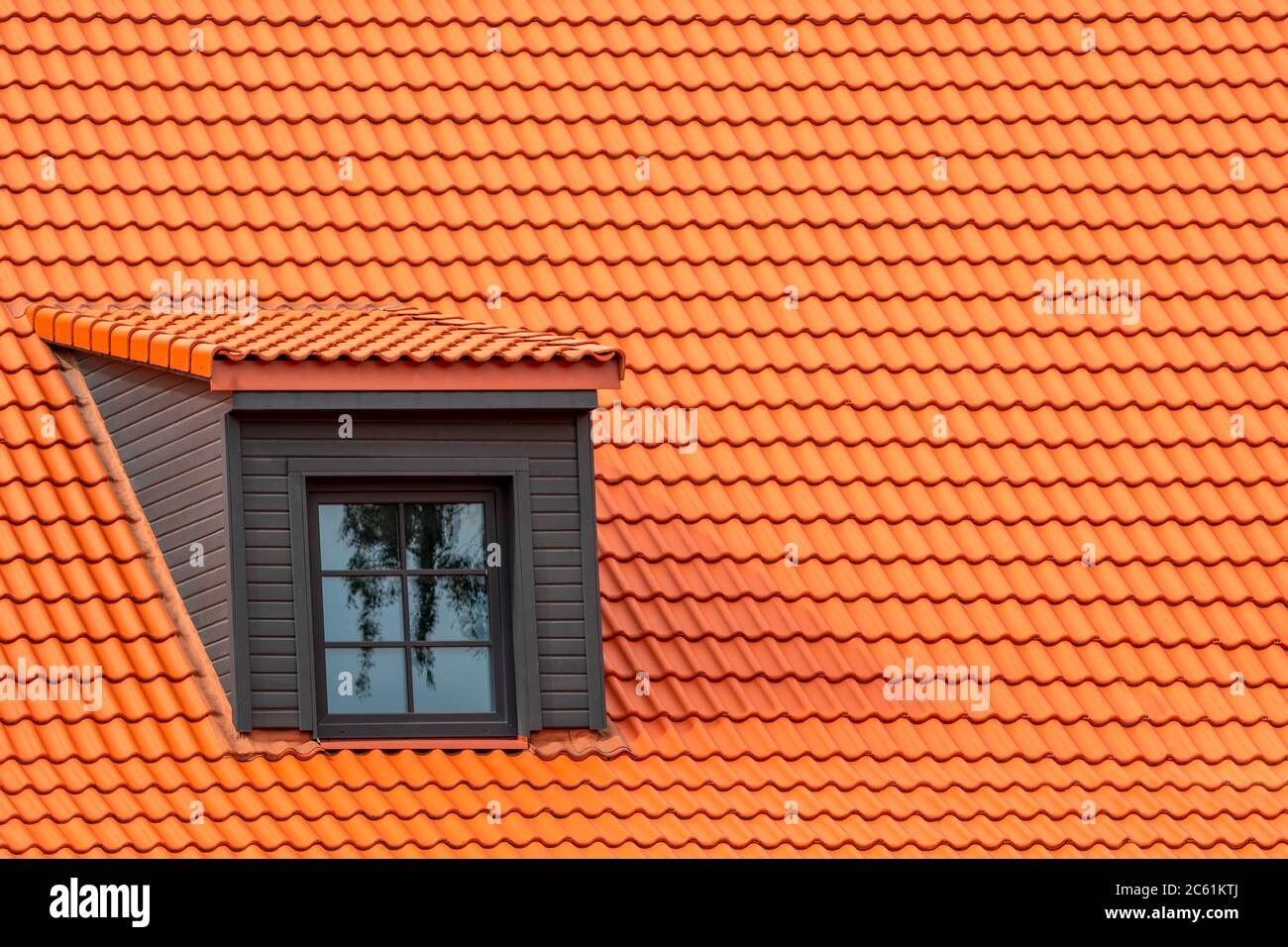 Renovated dormer window on the red house clay ceramic tiles roof Stock ...