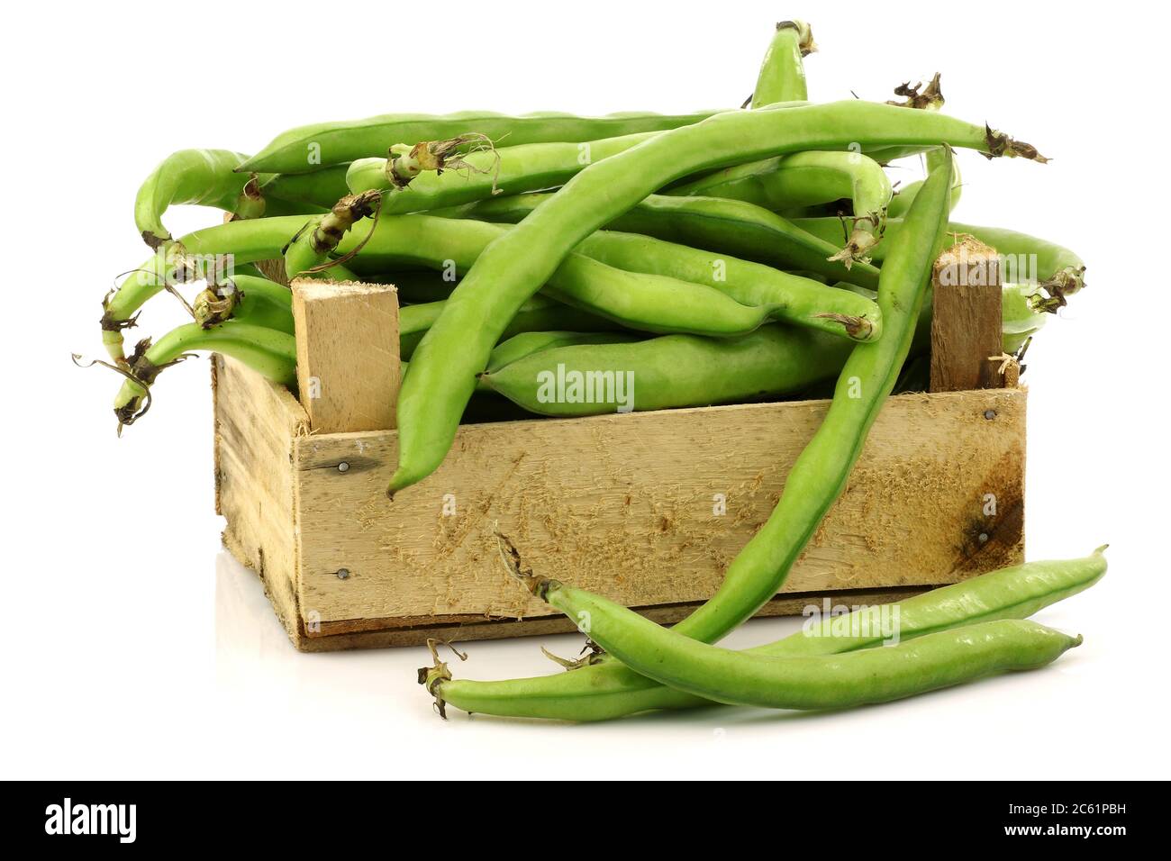 bunch of broad beans in a wooden box on a white background Stock Photo ...