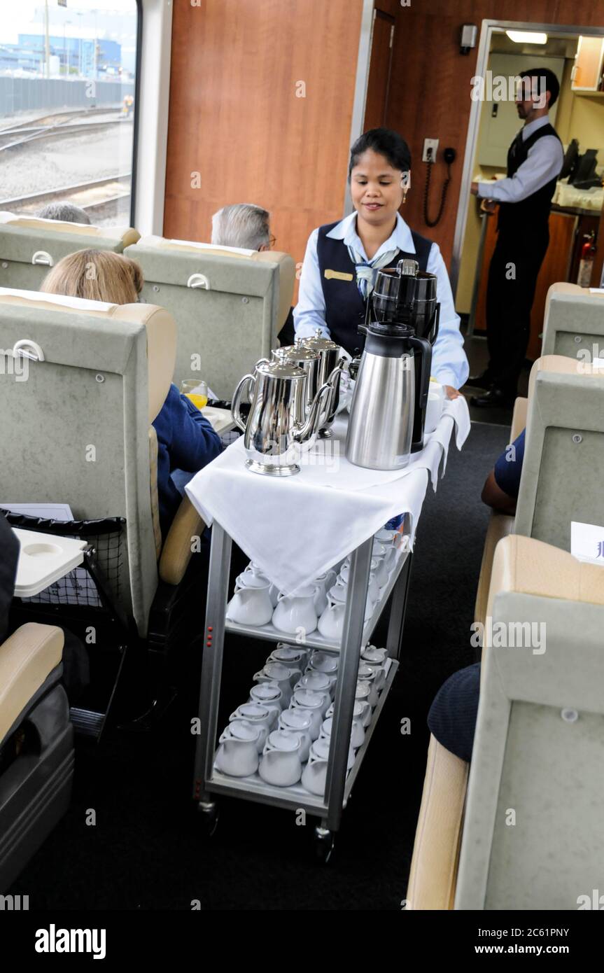 A restaurant-car attendant serving coffee and tea on board the Rocky ...