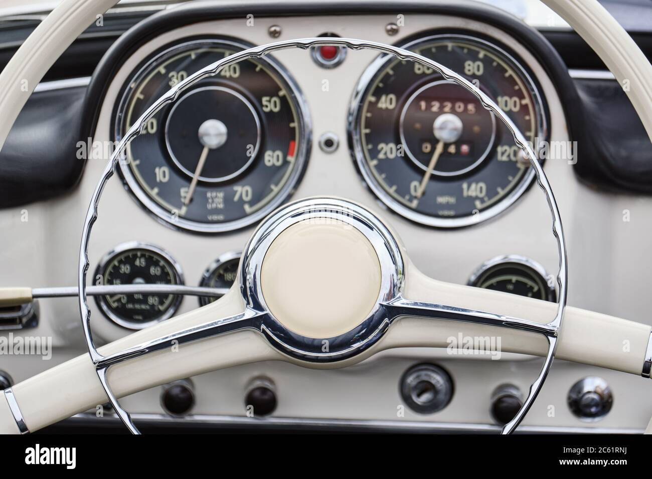Original white steering wheel in a retro car Stock Photo - Alamy