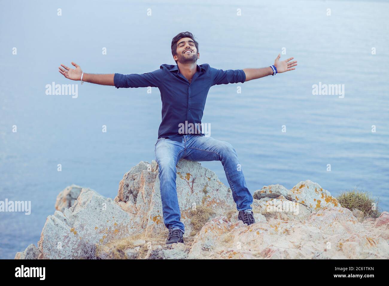 Man smiling looking up to blue sky taking deep breath celebrating ...