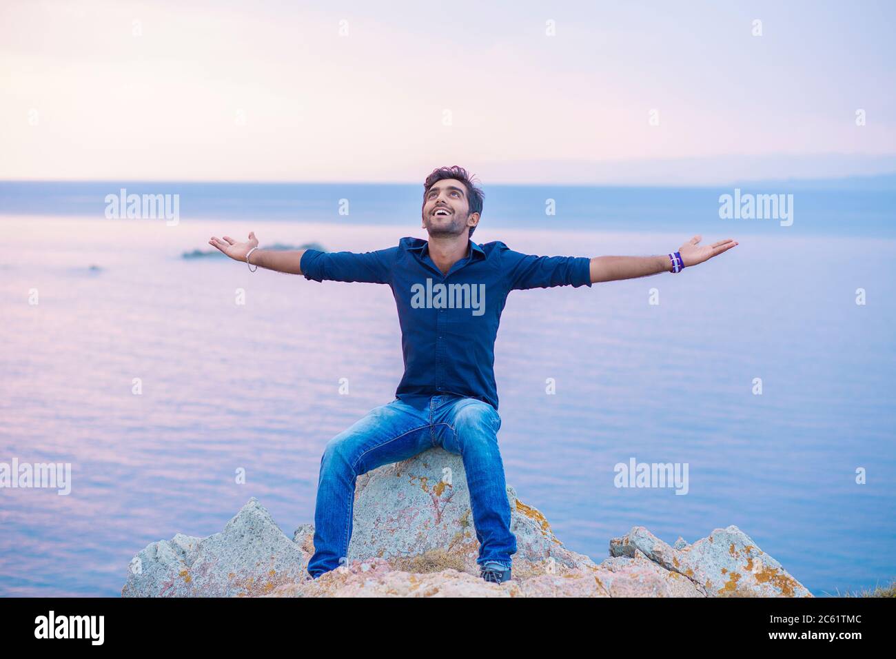 Man smiling looking up to blue sky taking deep breath celebrating ...