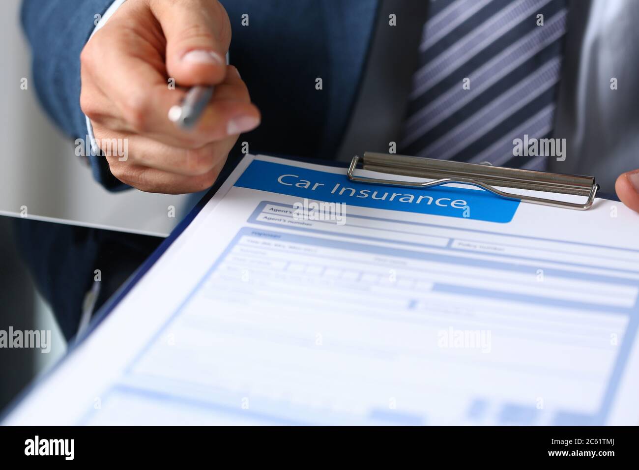 Man is holding car insurance claim form Stock Photo - Alamy