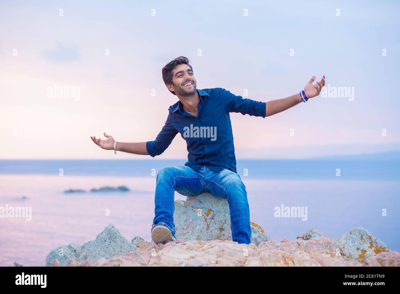 Man smiling looking up to blue sky taking deep breath celebrating ...