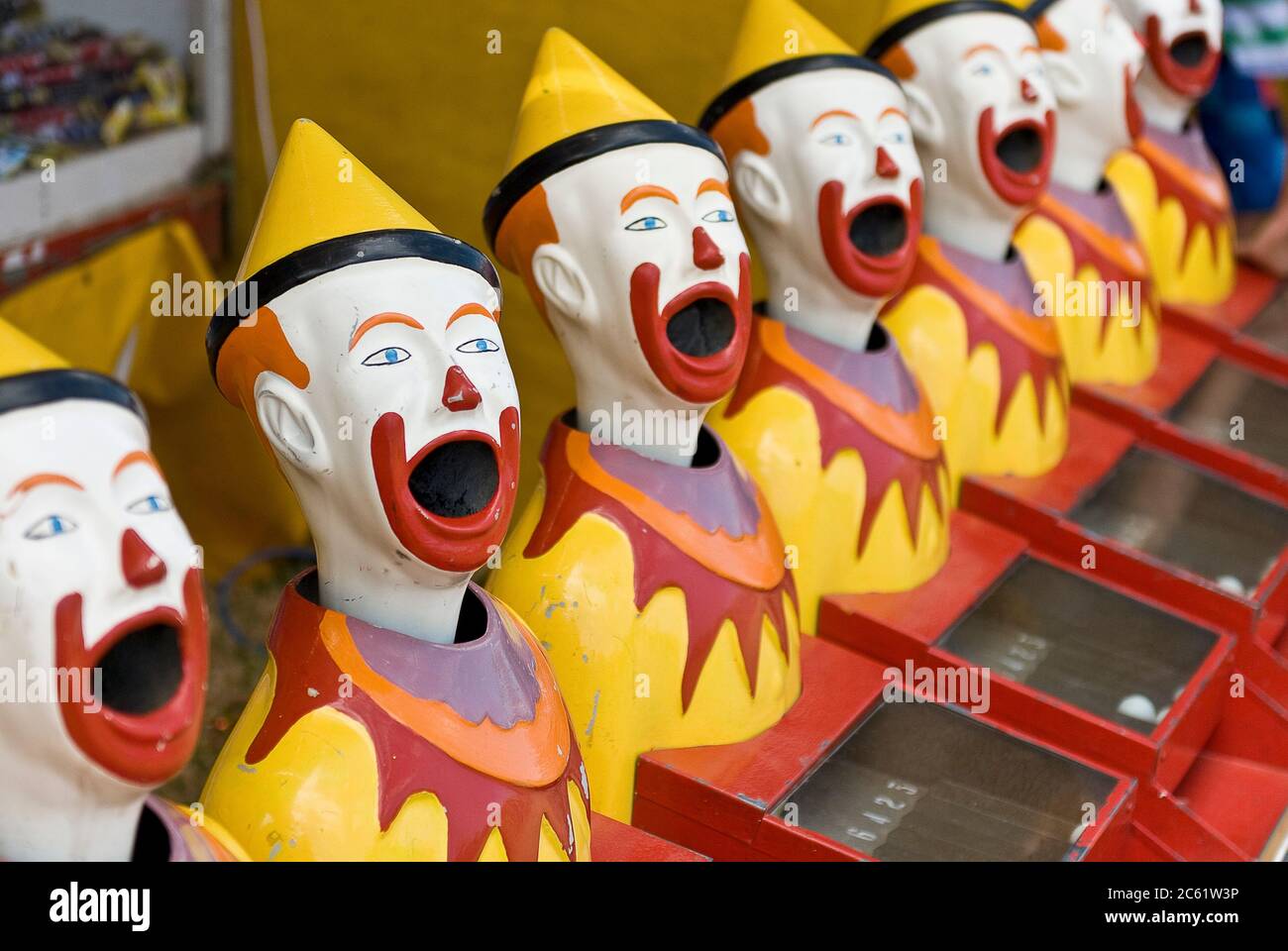 Brightly colored sideshow clowns at a circus Stock Photo - Alamy