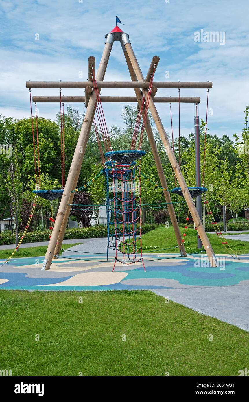 Multifunctional log tower in playground designed for climbing on ropes ...