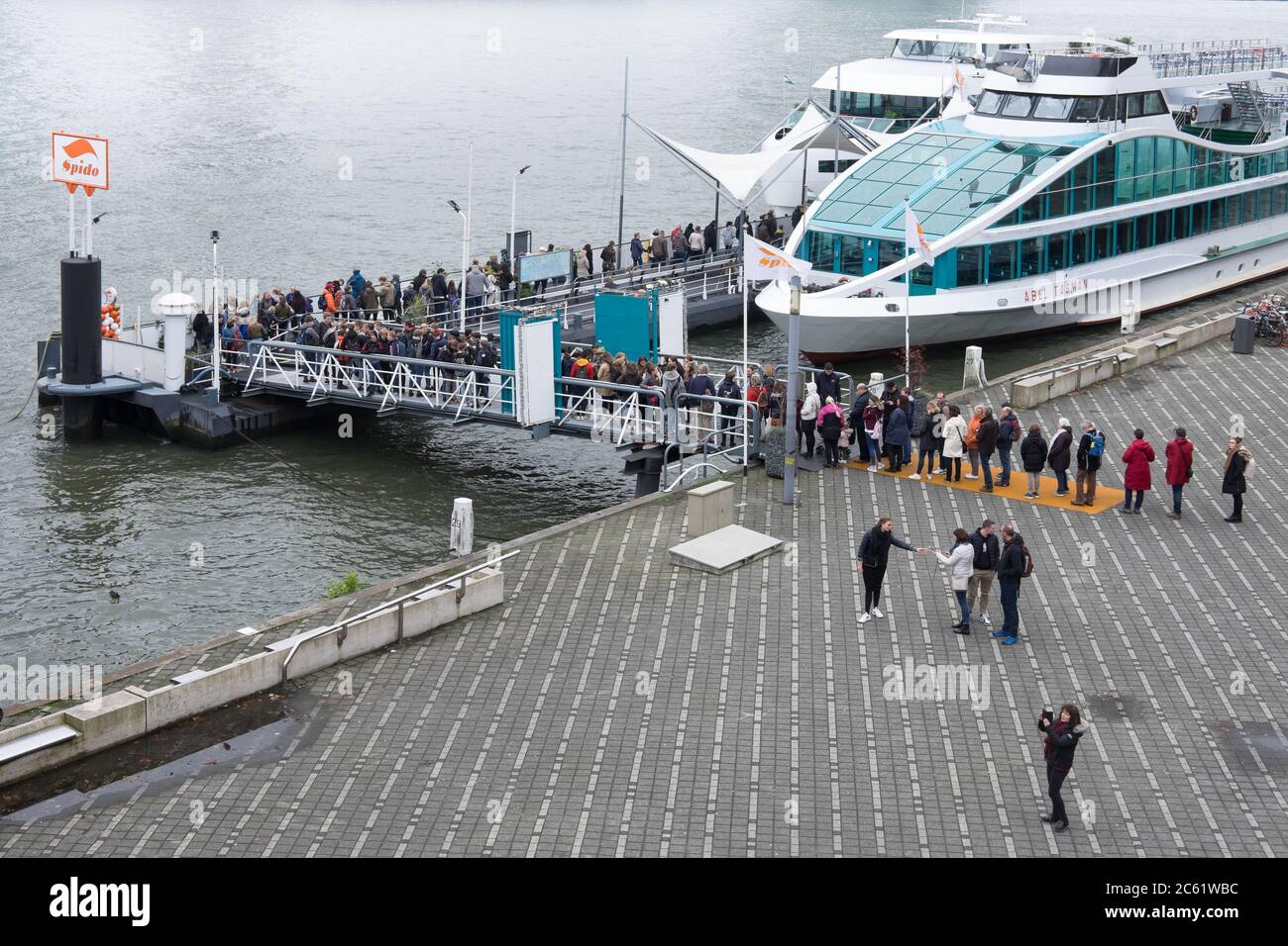 People board and disembark from Spido tourboats on the waterfront in ...