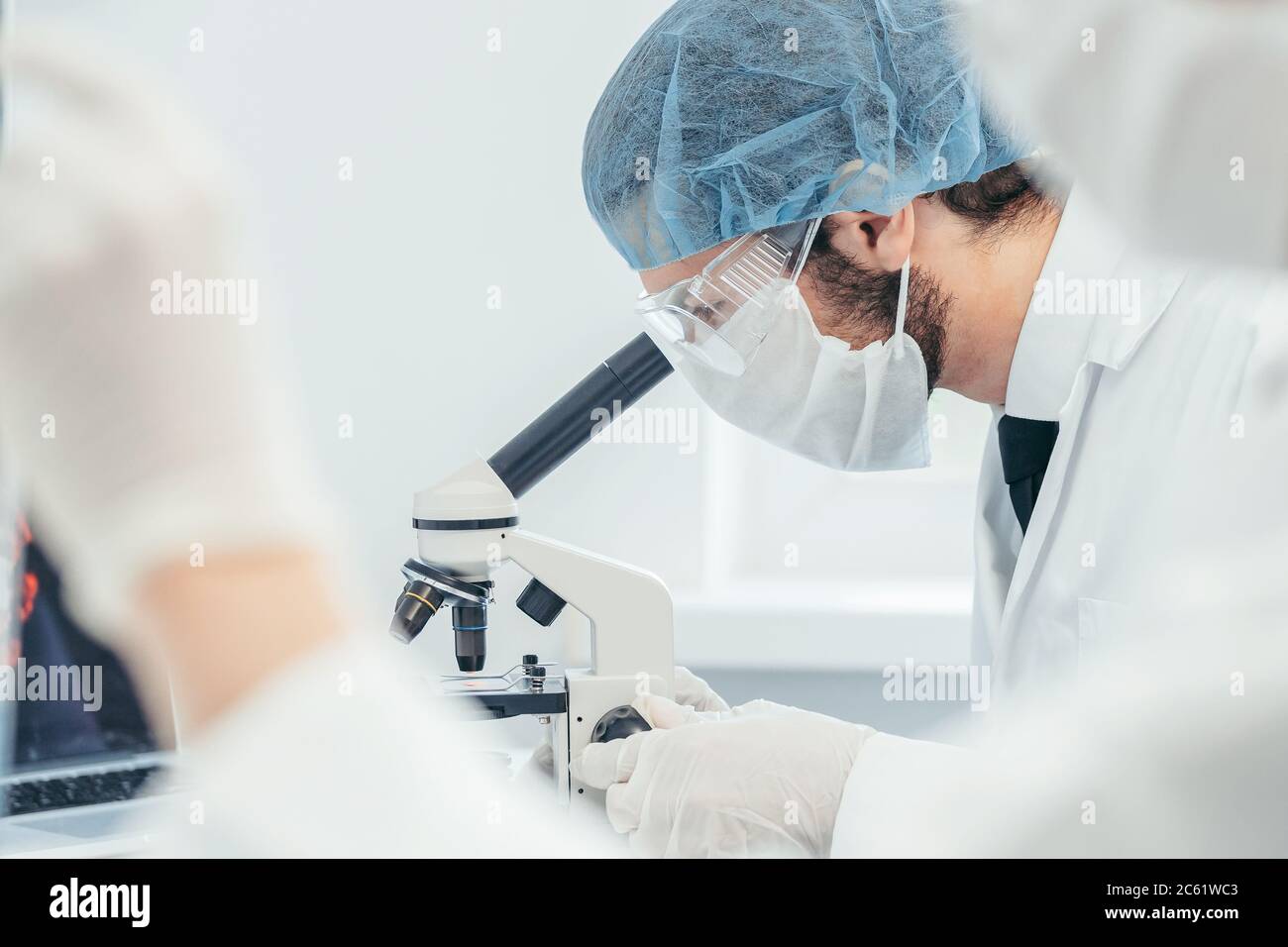 close up. a group of doctors and scientists work in the laboratory ...