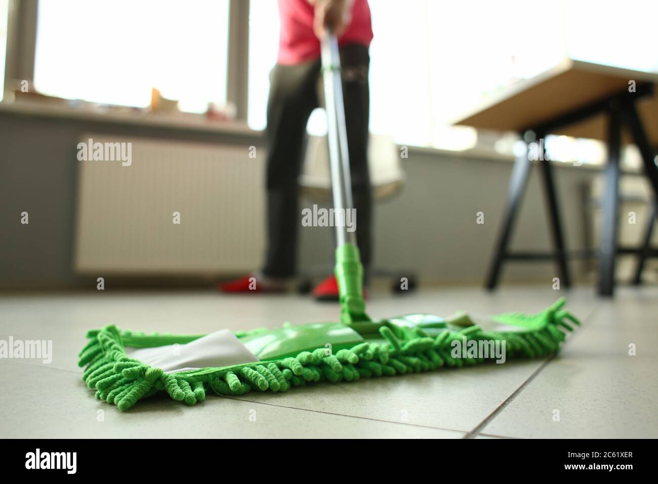 Cleaning service man mopping the floor in the room Stock Photo - Alamy