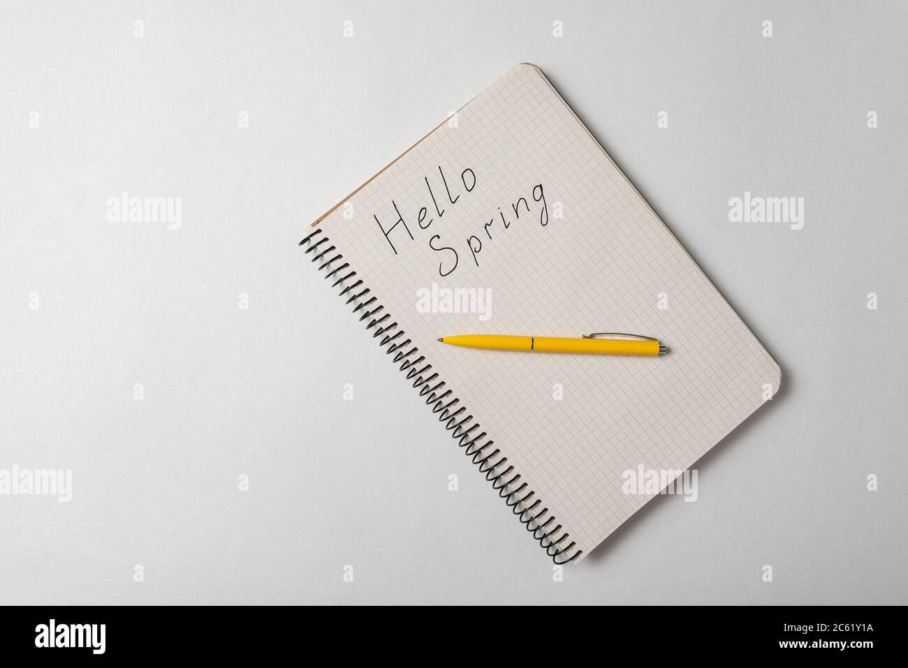 Hello spring handwriting notice. Top view on Notepad and pen on white ...