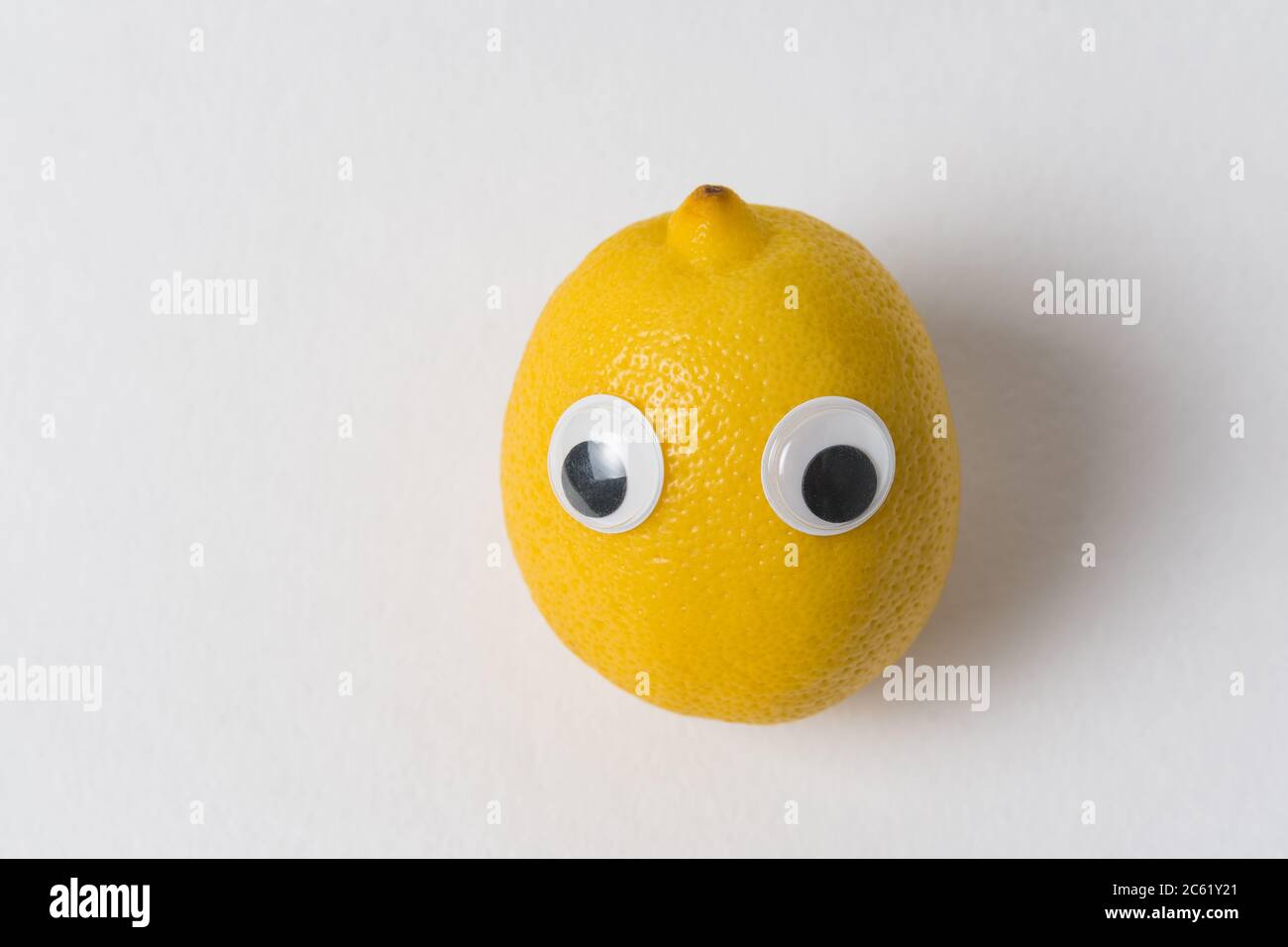 Fresh lemon with eyes on white background. Fruit with Funny Faces Stock ...