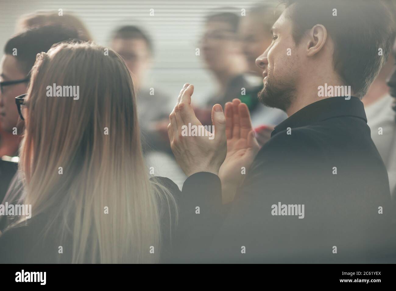 through the glass. a group of young business people applauding Stock ...