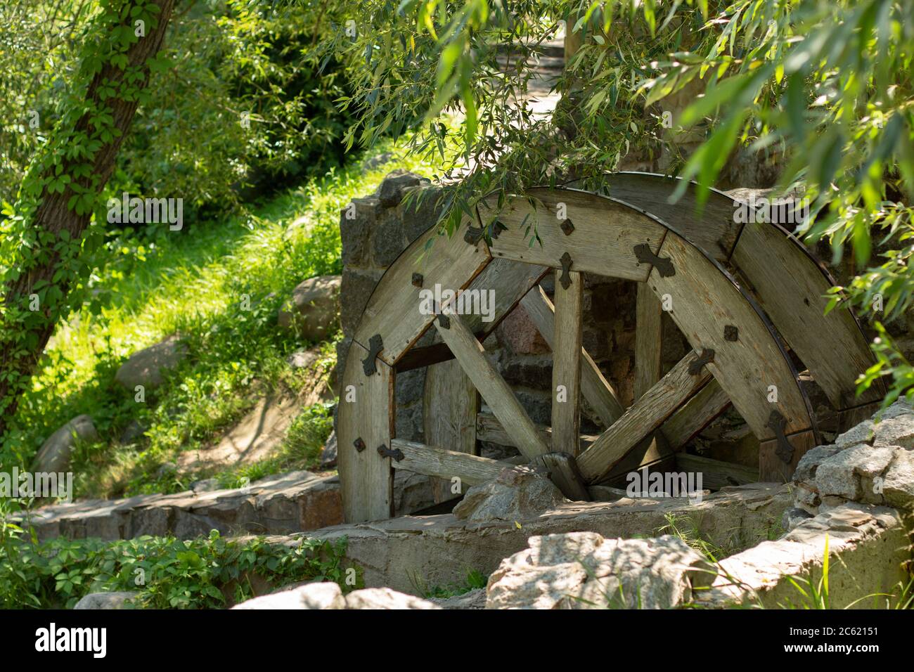 old wooden water pumping wheel on river Stock Photo - Alamy