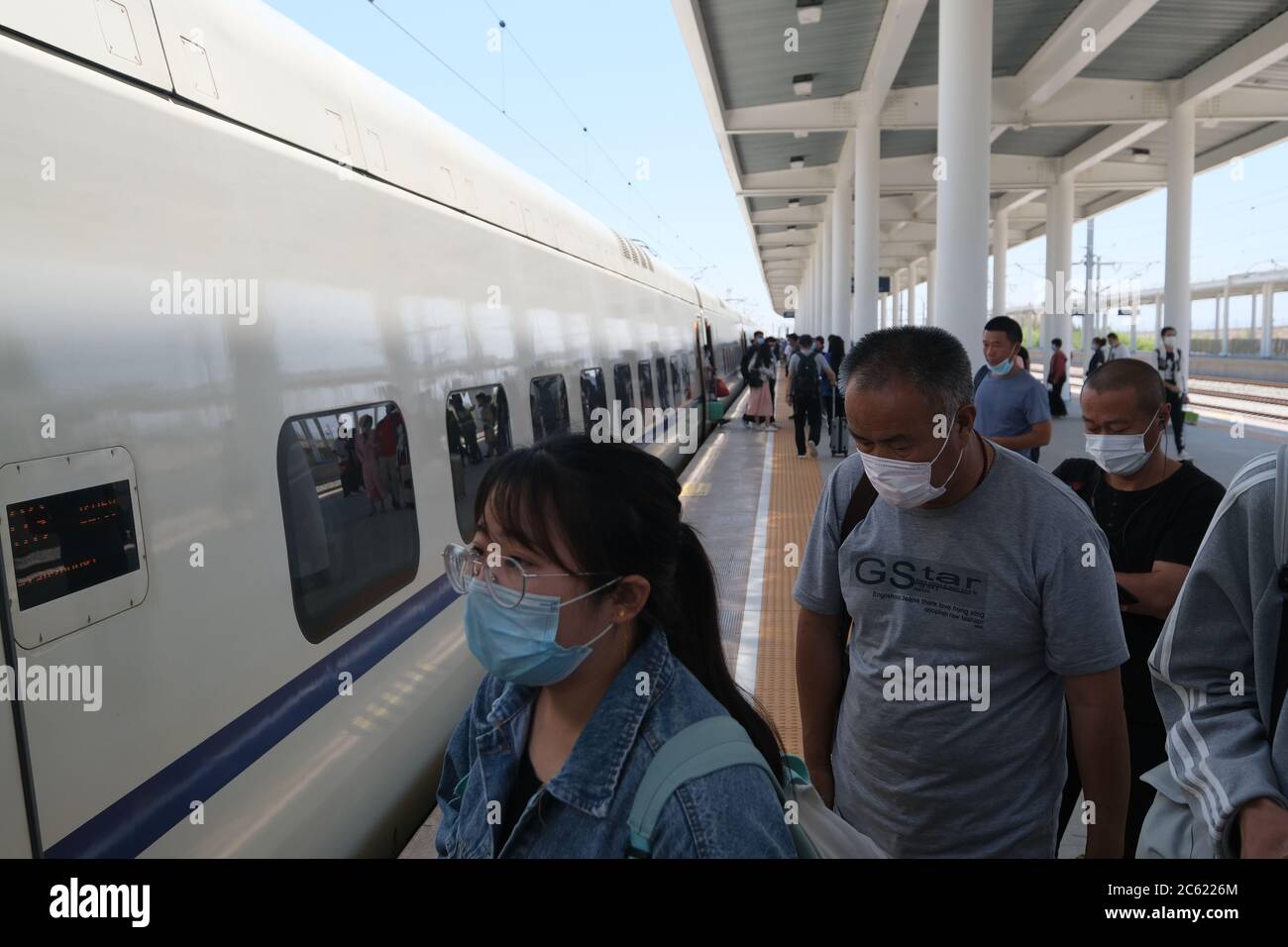 passengers wearing face mask to prevent COVID-19, boarding into high ...