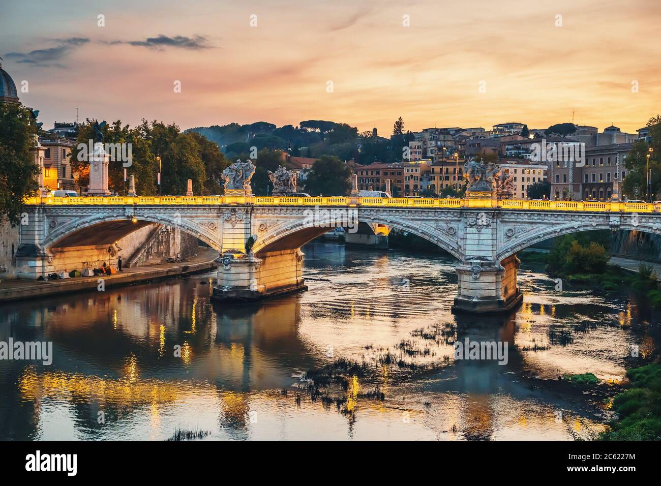 Tiber river with illuminated bridge in Rome evening at sunset, Italy ...