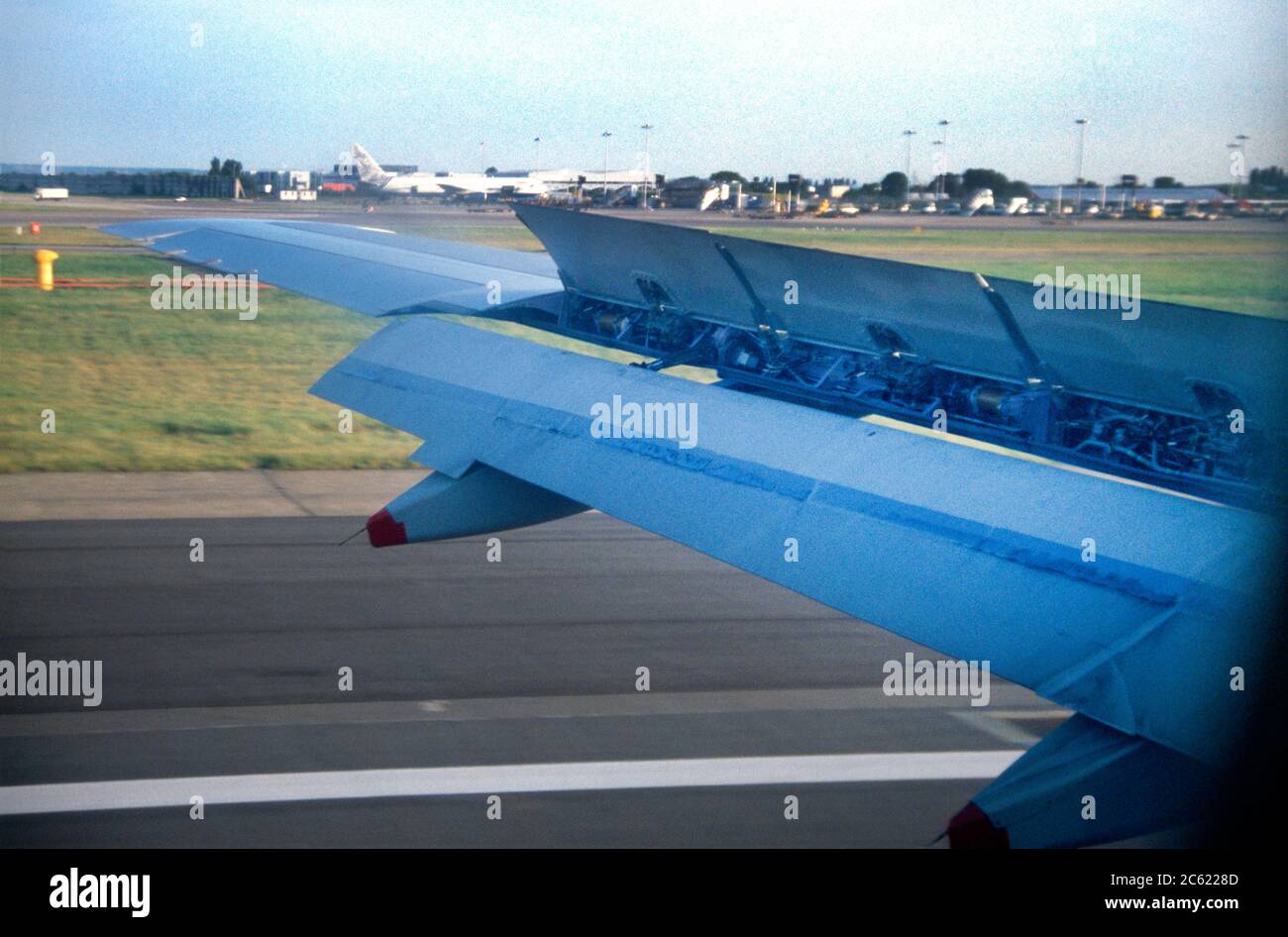 Wing Of Aeroplane Landing & Breaking Windflaps Up Stock Photo - Alamy