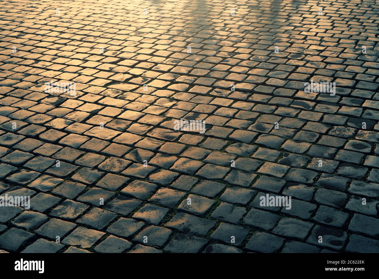 Cobblestone pavement stones at sunset light, old European street ...
