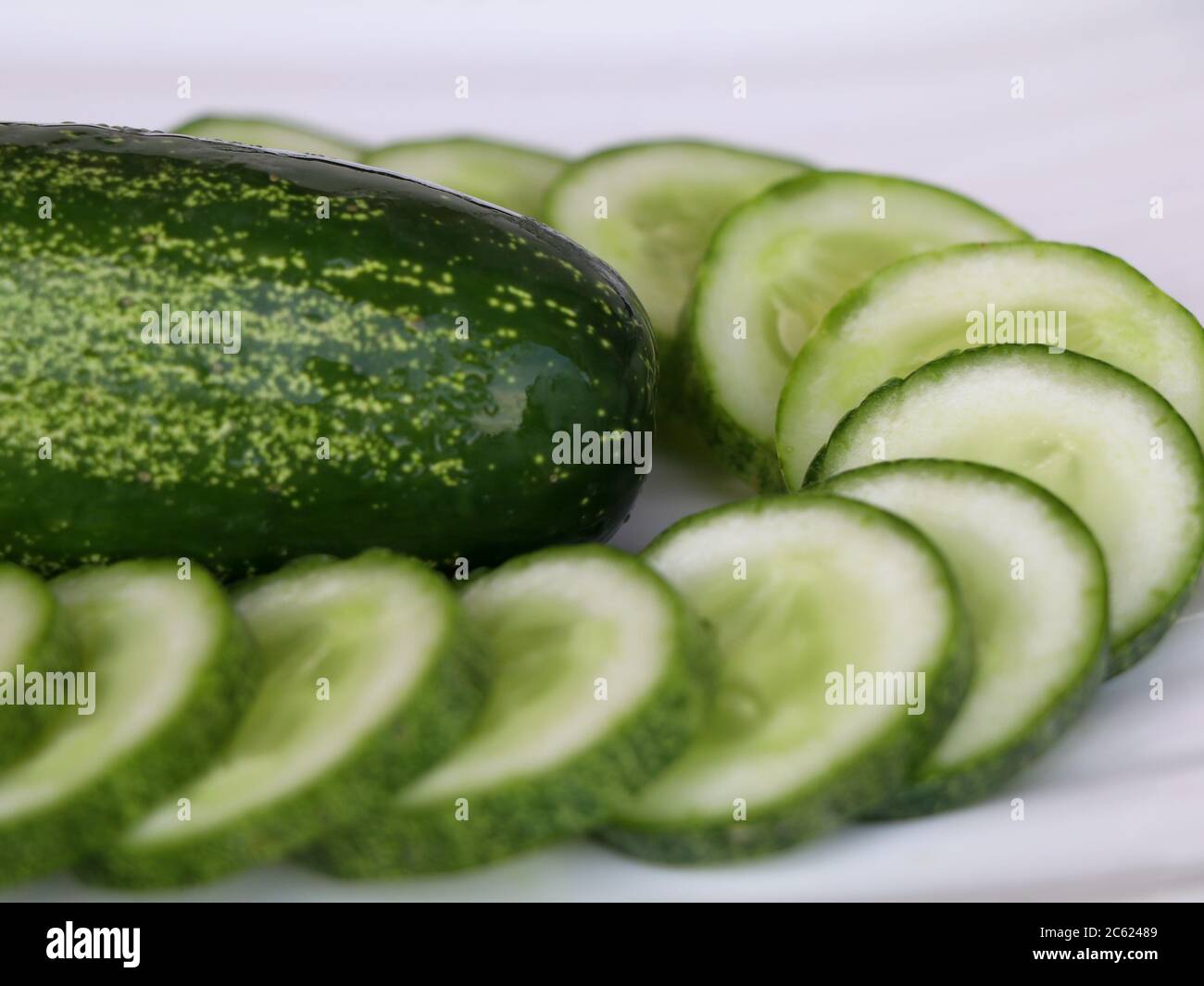 Fresh raw cucumber with sliced ones- organic and healthy vegetable ...