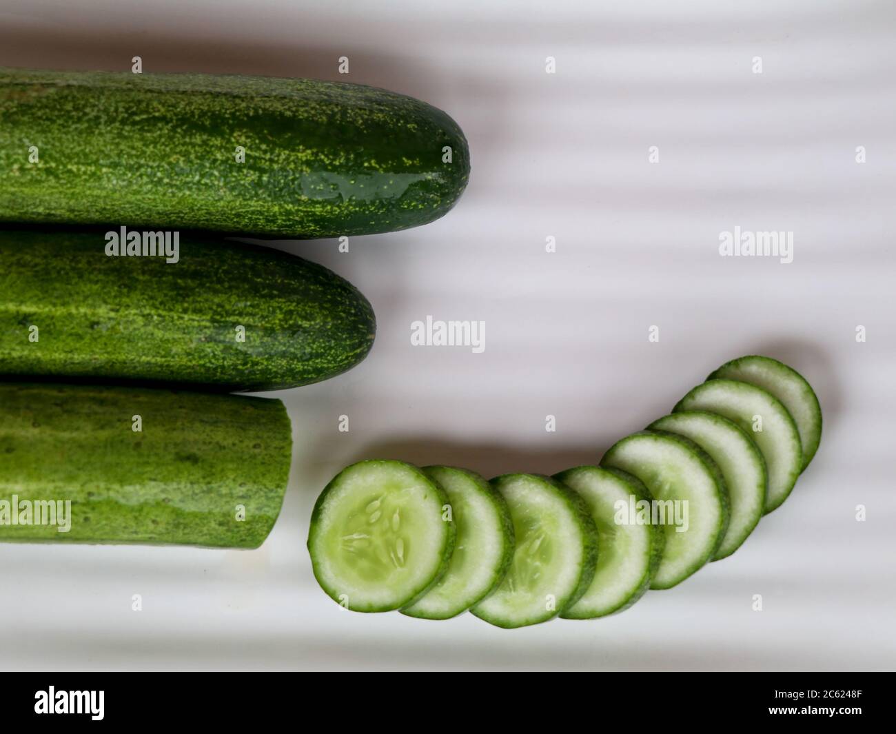 Fresh raw cucumber with sliced ones- organic and healthy vegetable ...