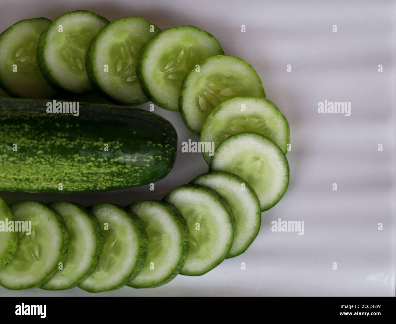 Fresh raw cucumber with sliced ones- organic and healthy vegetable ...