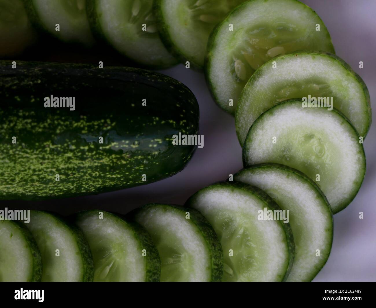 Fresh raw cucumber with sliced ones- organic and healthy vegetable ...