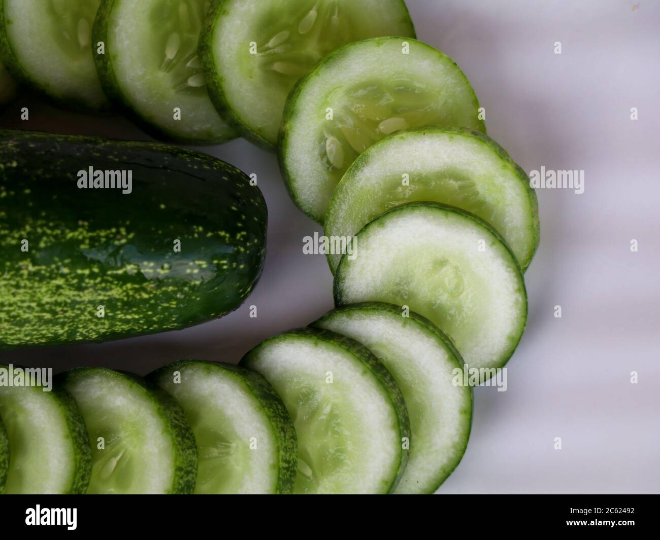 Fresh raw cucumber with sliced ones- organic and healthy vegetable ...