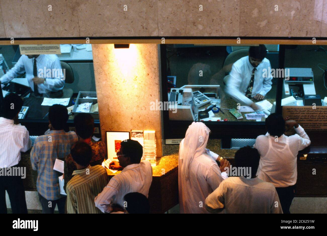 Dubai UAE Customers Queuing at Cashiers Desk in Bank Stock Photo - Alamy