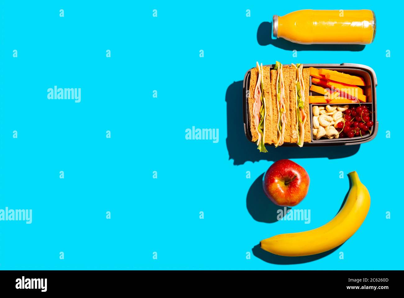 Healthy school lunch in a convenient container on a bright blue ...