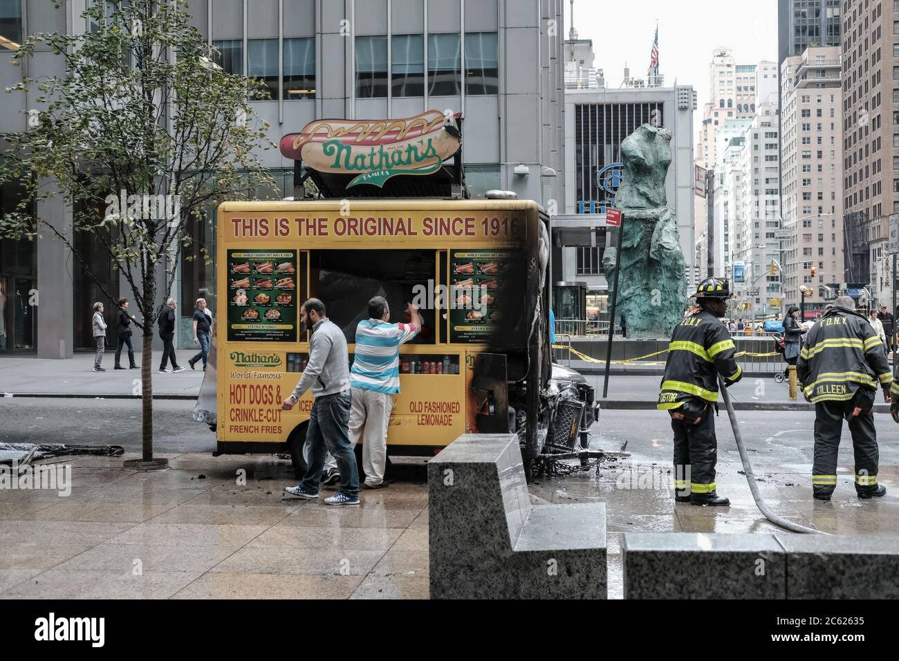 Both NYPD and Fire Department officers attending a fire near a busy New ...