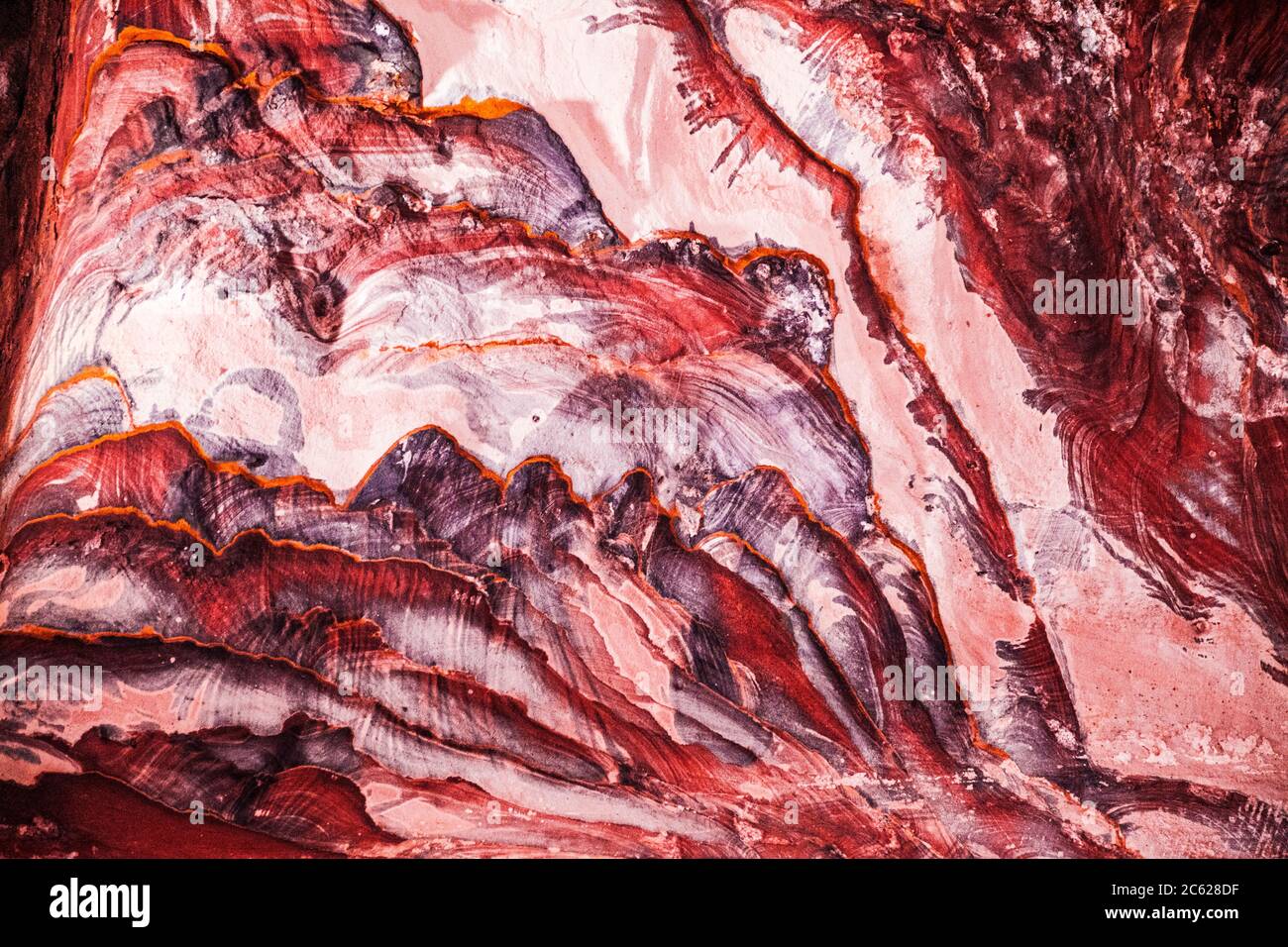 The red sandstone rock surface of the canyon known as Al Siq at the ...