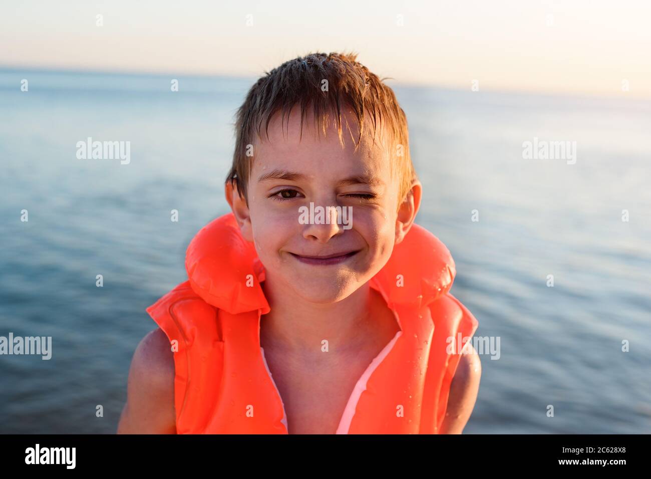 Cute boy with happy smile in inflatable swimming against the sea Stock ...