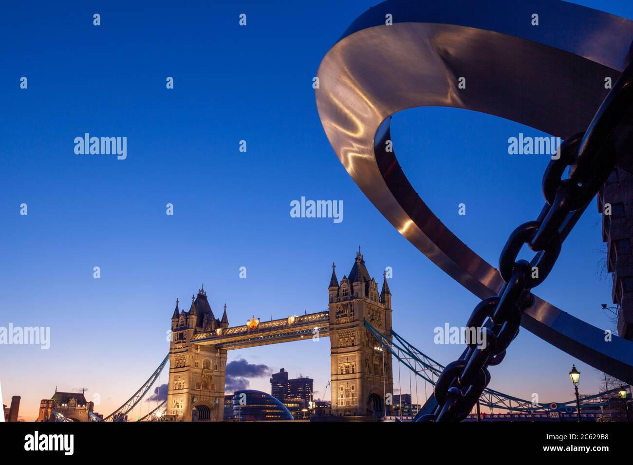 Timepiece Sculpture and Tower Bridge at Dusk, London, England Stock ...