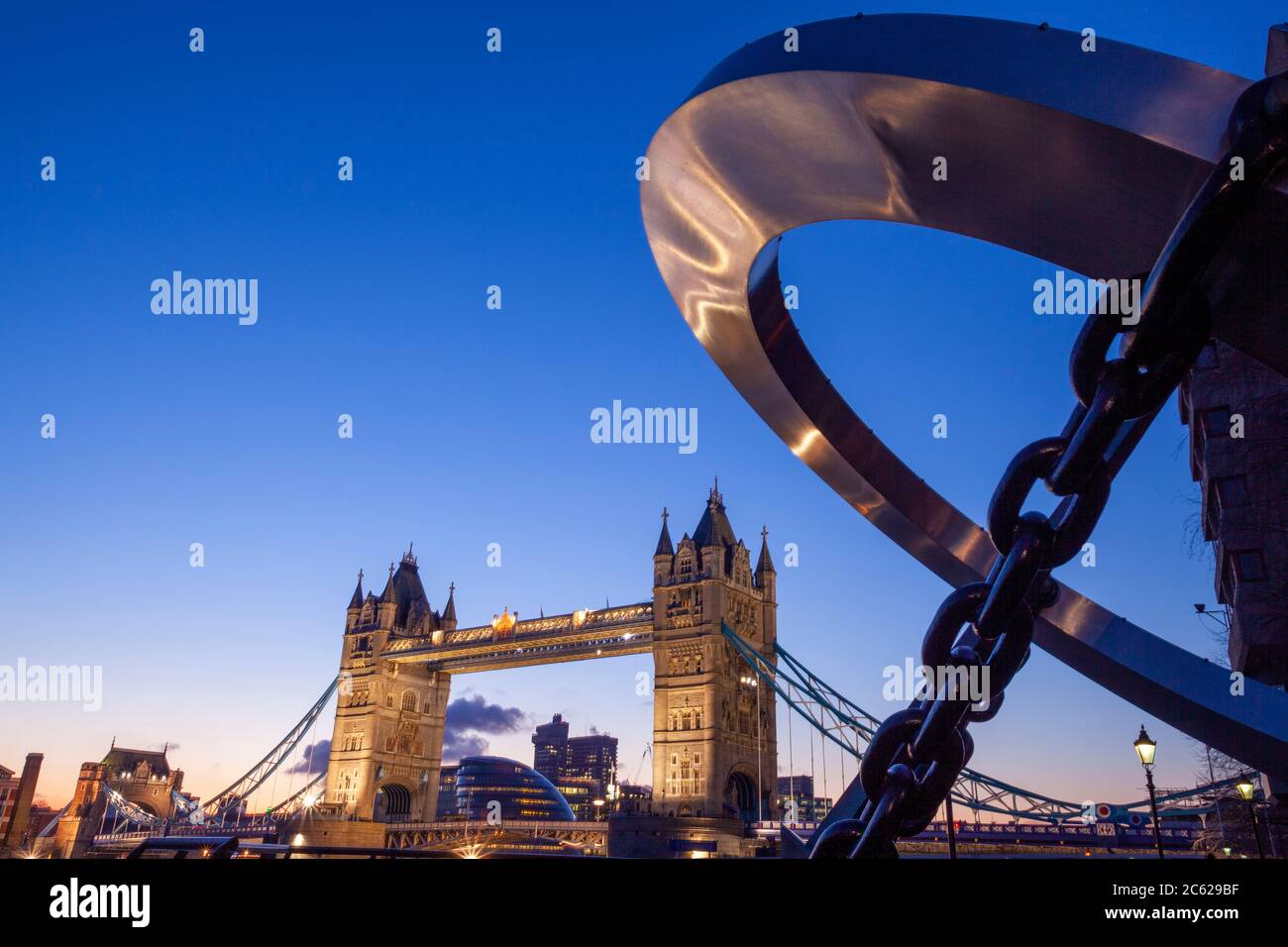 Timepiece Sculpture and Tower Bridge at Dusk, London, England Stock ...