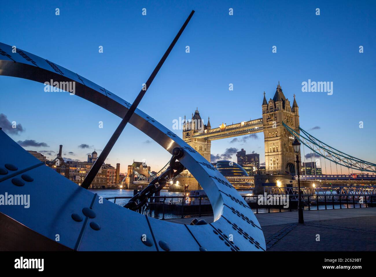 Timepiece Sculpture and Tower Bridge at Dusk, London, England Stock ...