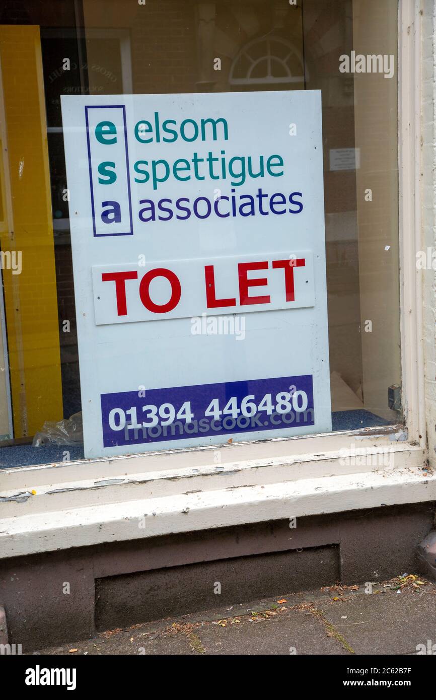 To Let estate agent sign in empty shop window, Elsom Spettigue ...