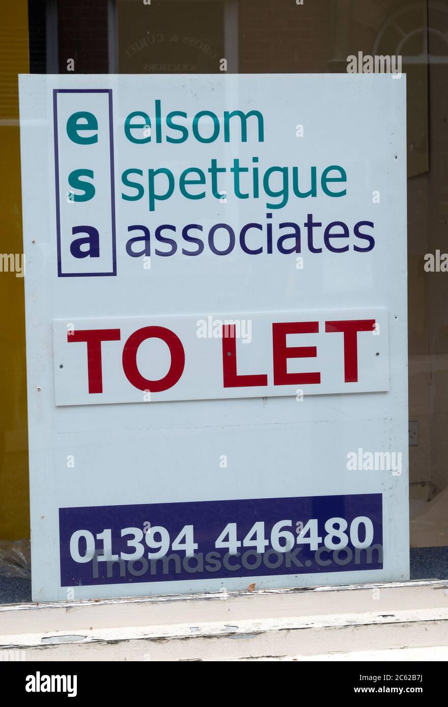 To Let estate agent sign in empty shop window, Elsom Spettigue ...