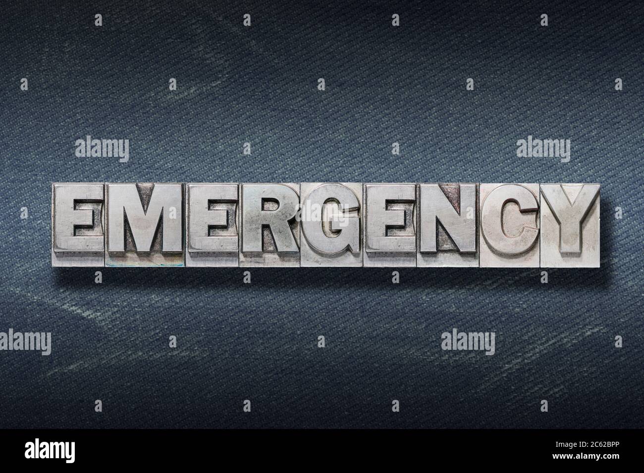 emergency word den word made from metallic letterpress on dark jeans ...