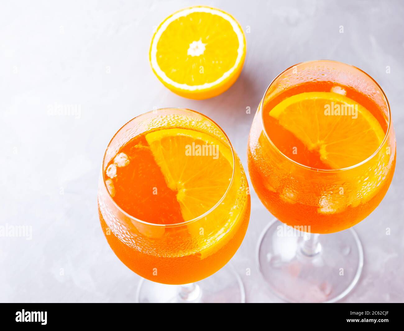 Aperol spritz cocktail on a gray background. Two glasses of aperol ... Aperol spritz cocktail on a gray background. Two glasses of aperol ...