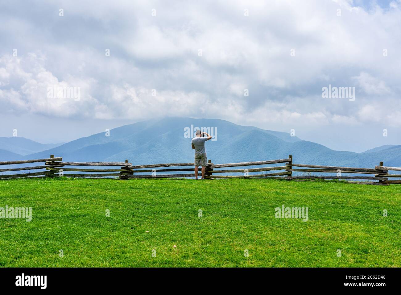 Devil's Knob Overlook with photographer man in green grass lawn field ...