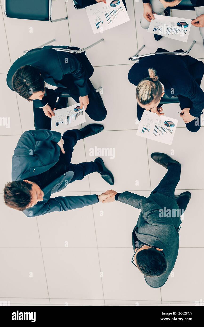 business colleagues supporting each other with a handshake Stock Photo ...