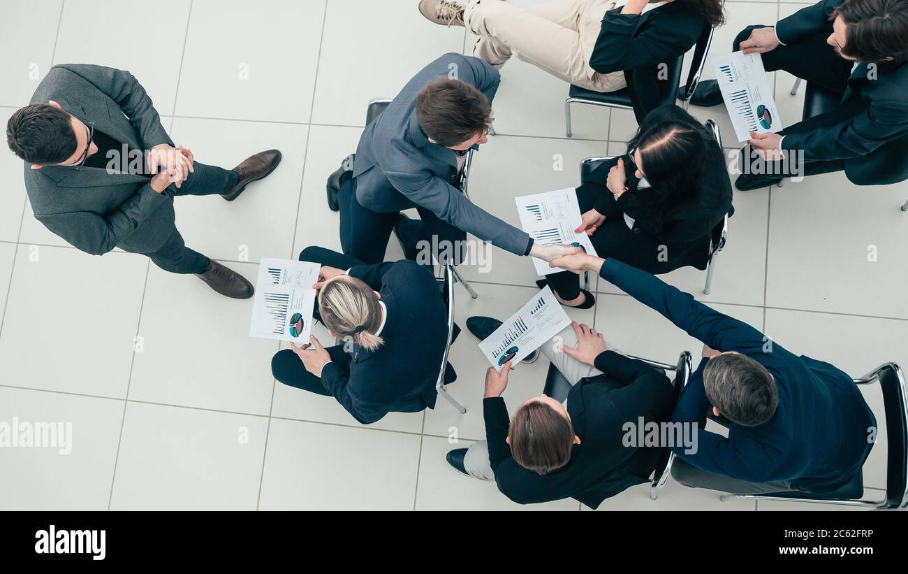 young employees supporting each other with a handshake Stock Photo - Alamy