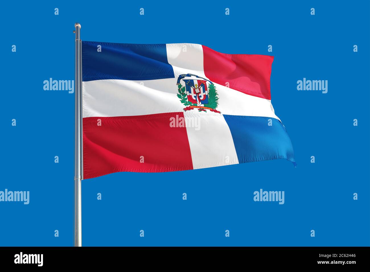 Dominican Republic national flag waving in the wind on a deep blue sky ...