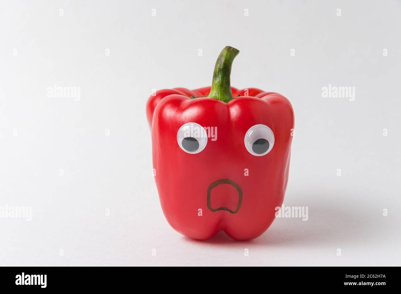 Red bell pepper with funny face. Pepper-smiley with Googly eyes over ...