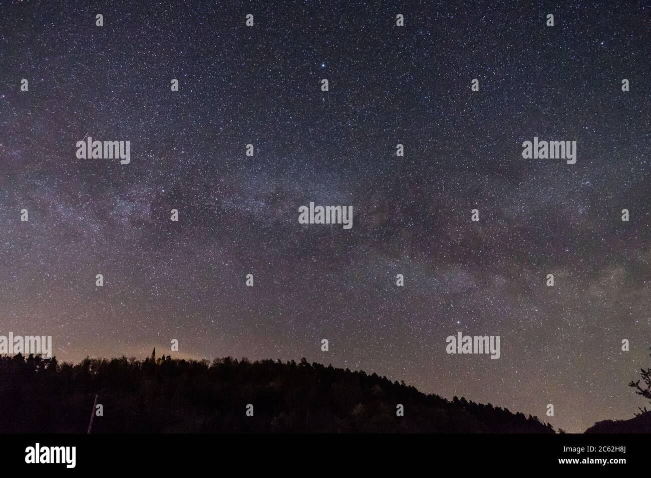 Germany, Moving star field of milky way galaxy core over swabian alb ...