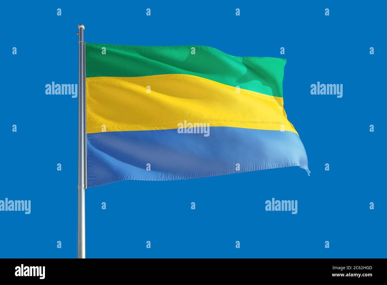 Gabon national flag waving in the wind on a deep blue sky. High quality ...