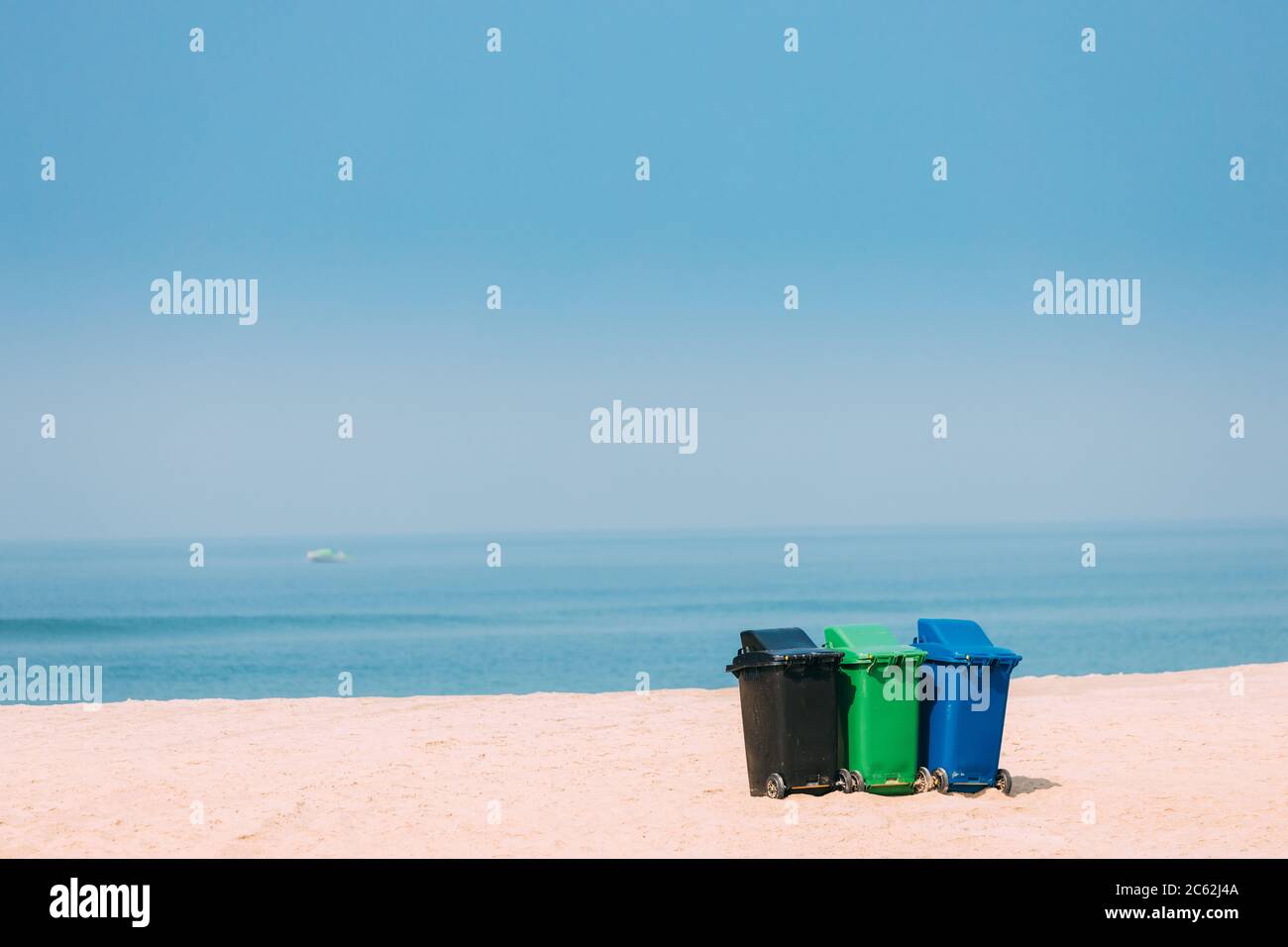 Three Colorful Plastic Waste Containers On Wheels For Separate ...