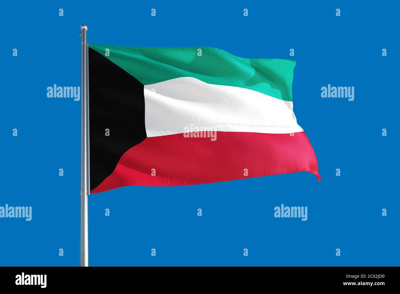 Kuwait national flag waving in the wind on a deep blue sky. High ...