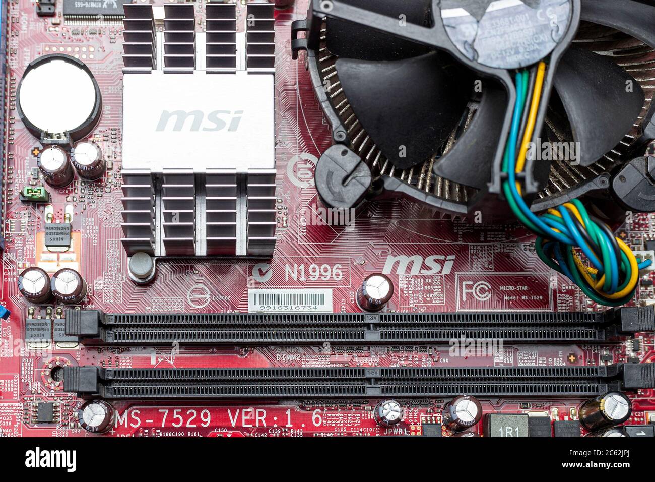 Ukraine - April 25, 2020: PC motherboard with cooling fan. Close-up and ...