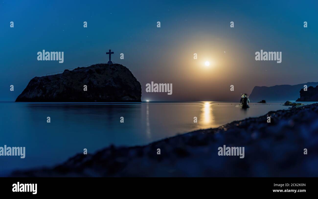 Starry night with a full moon over sea with rock in front. Cape Fiolent ...